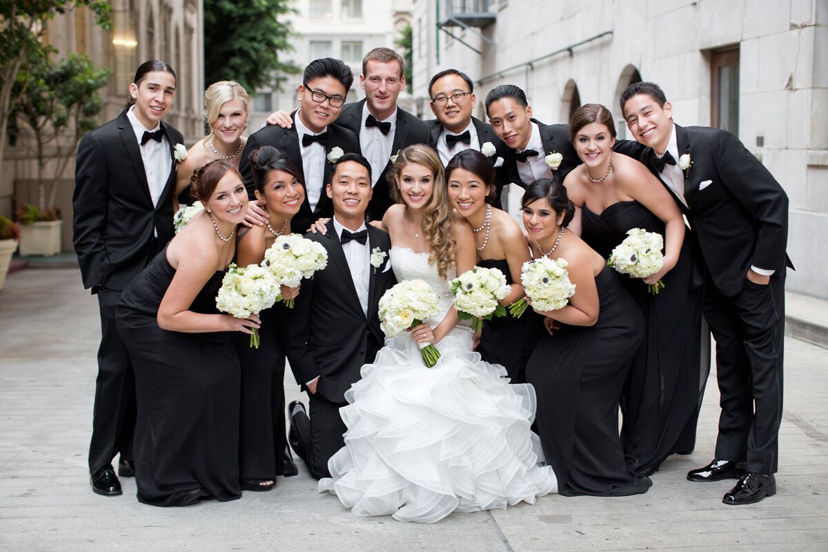Huddled Bride and Groom With Wedding Party