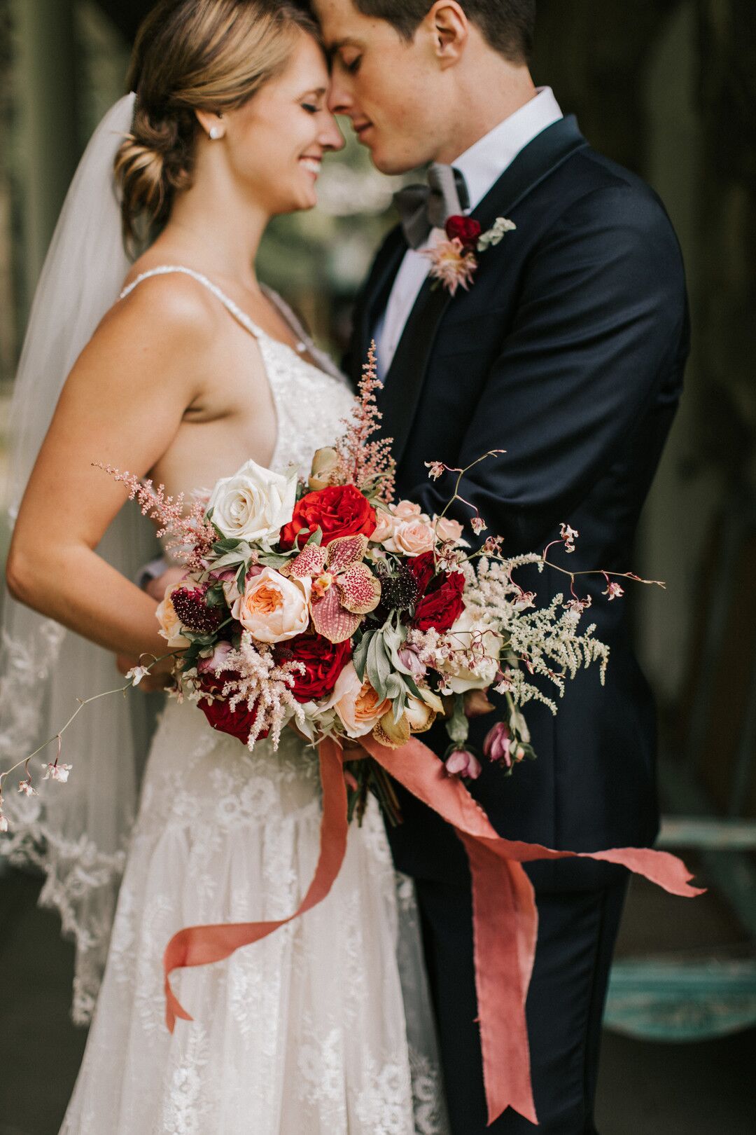 Bride and Groom Share A Dance by Rose Bouquet