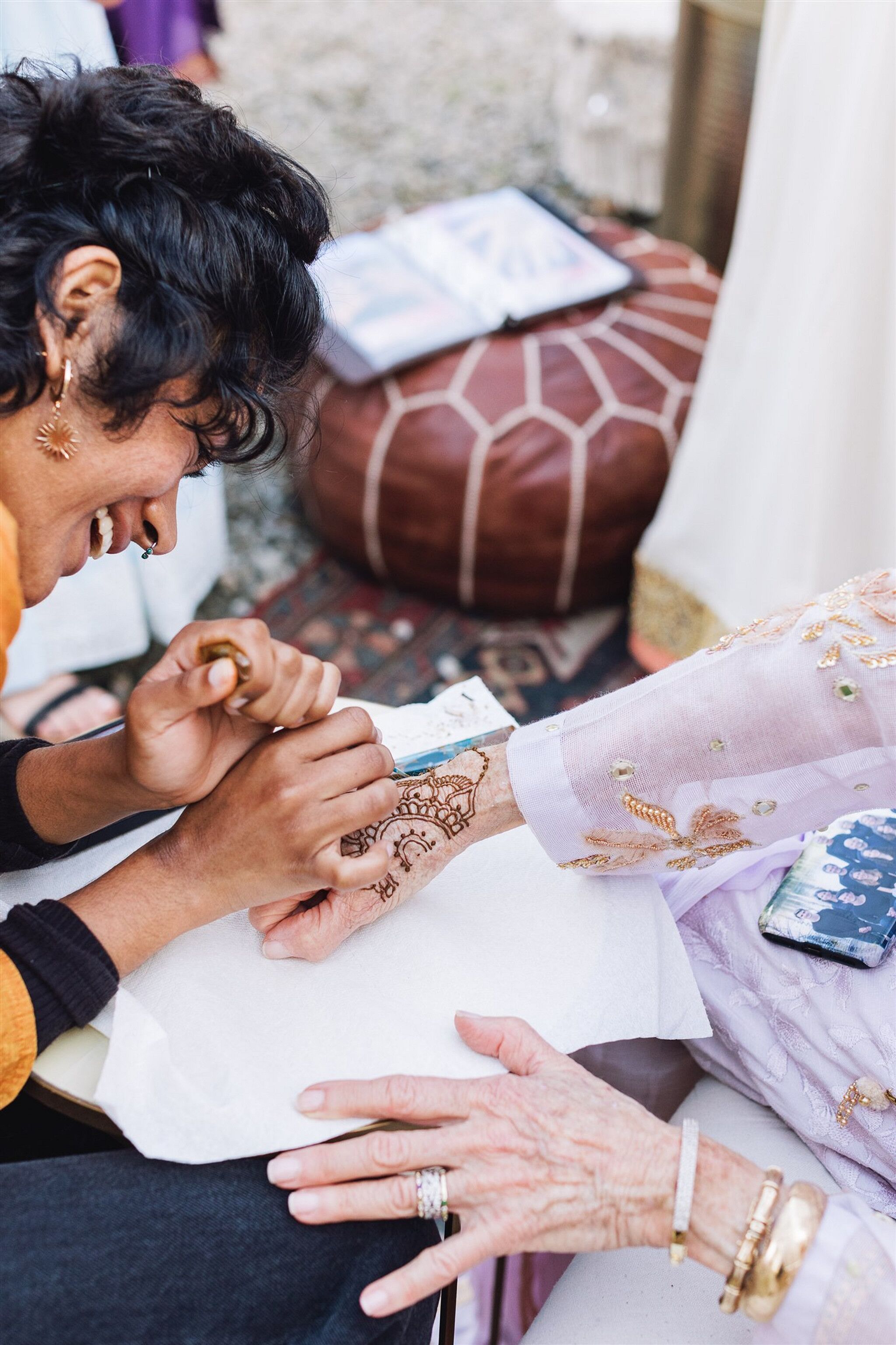 Mehendi Henna Artist Creating Henna on Wedding Guest's Hand