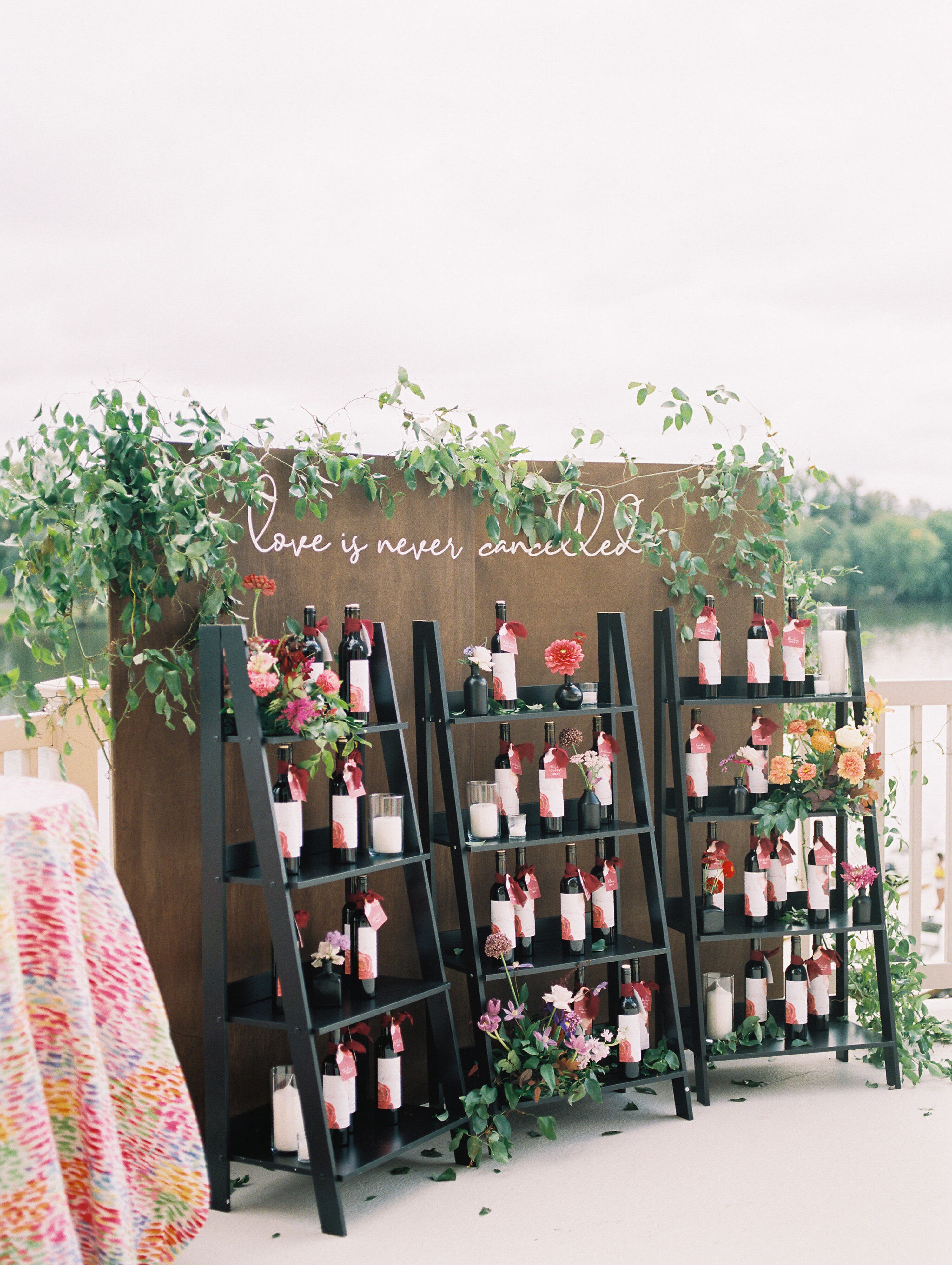 Favor Display Wall Filled With Homemade Wine