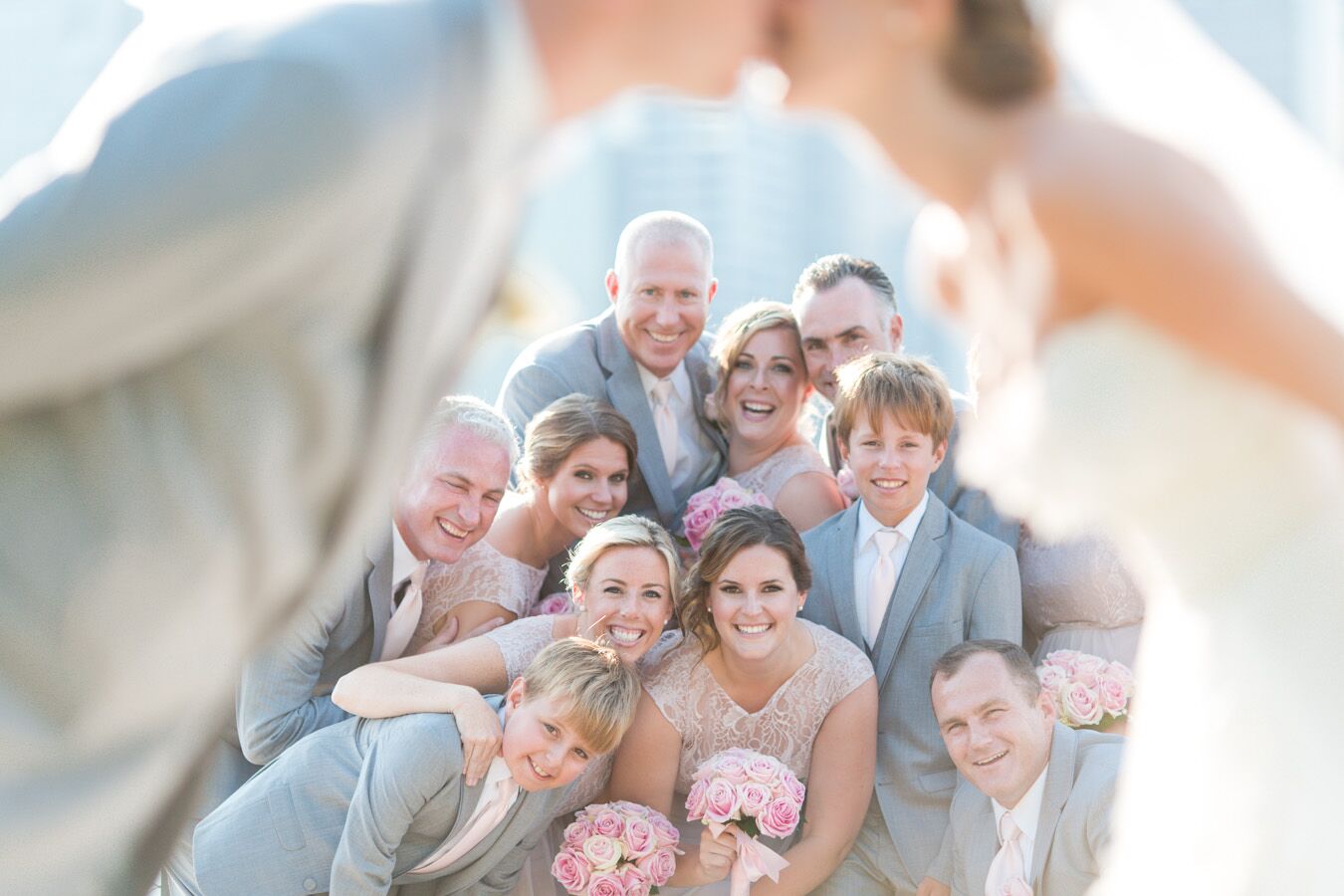 Bride and Groom Kiss with Wedding Party