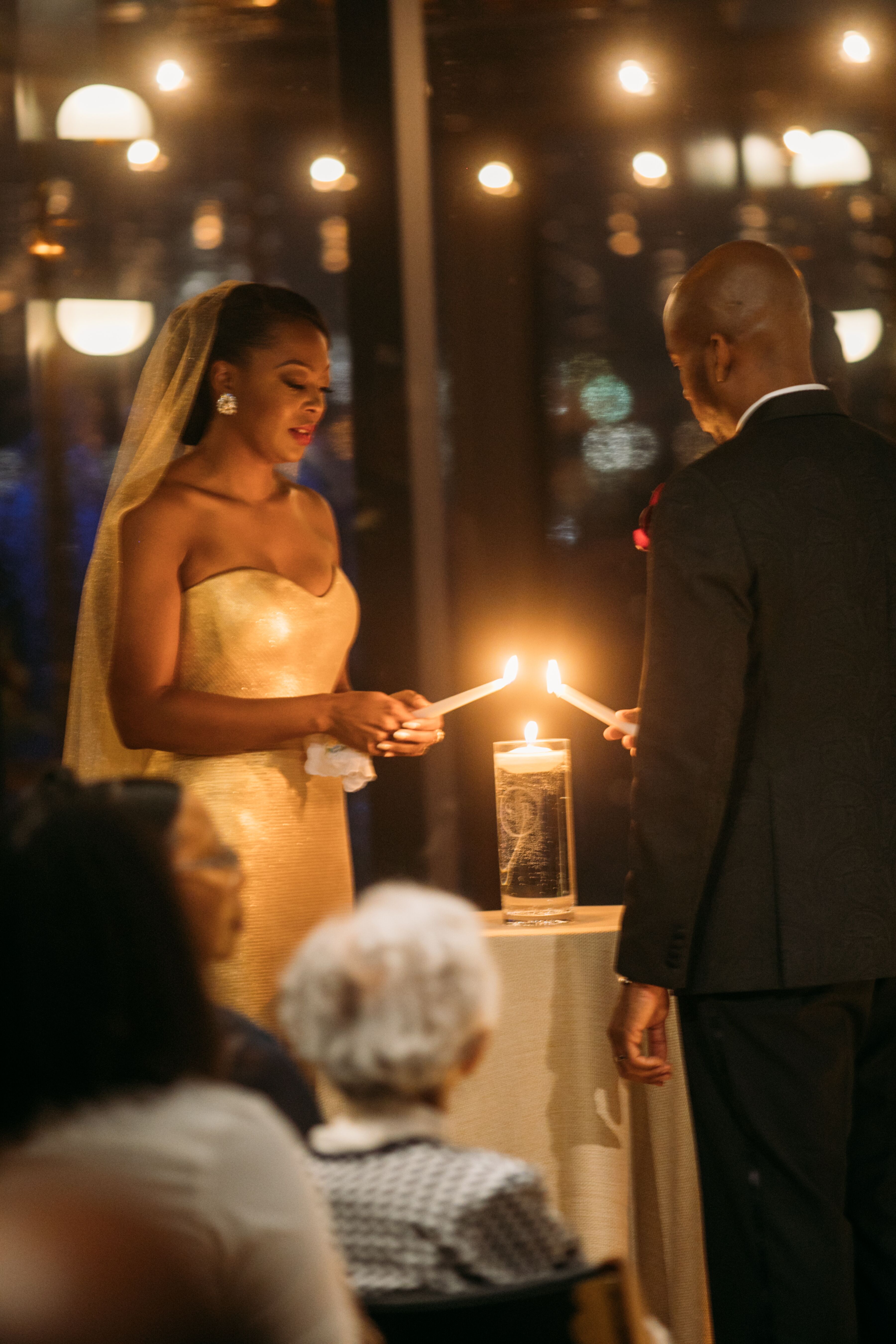 Romantic Couple Lighting Candle During Unity Ceremony
