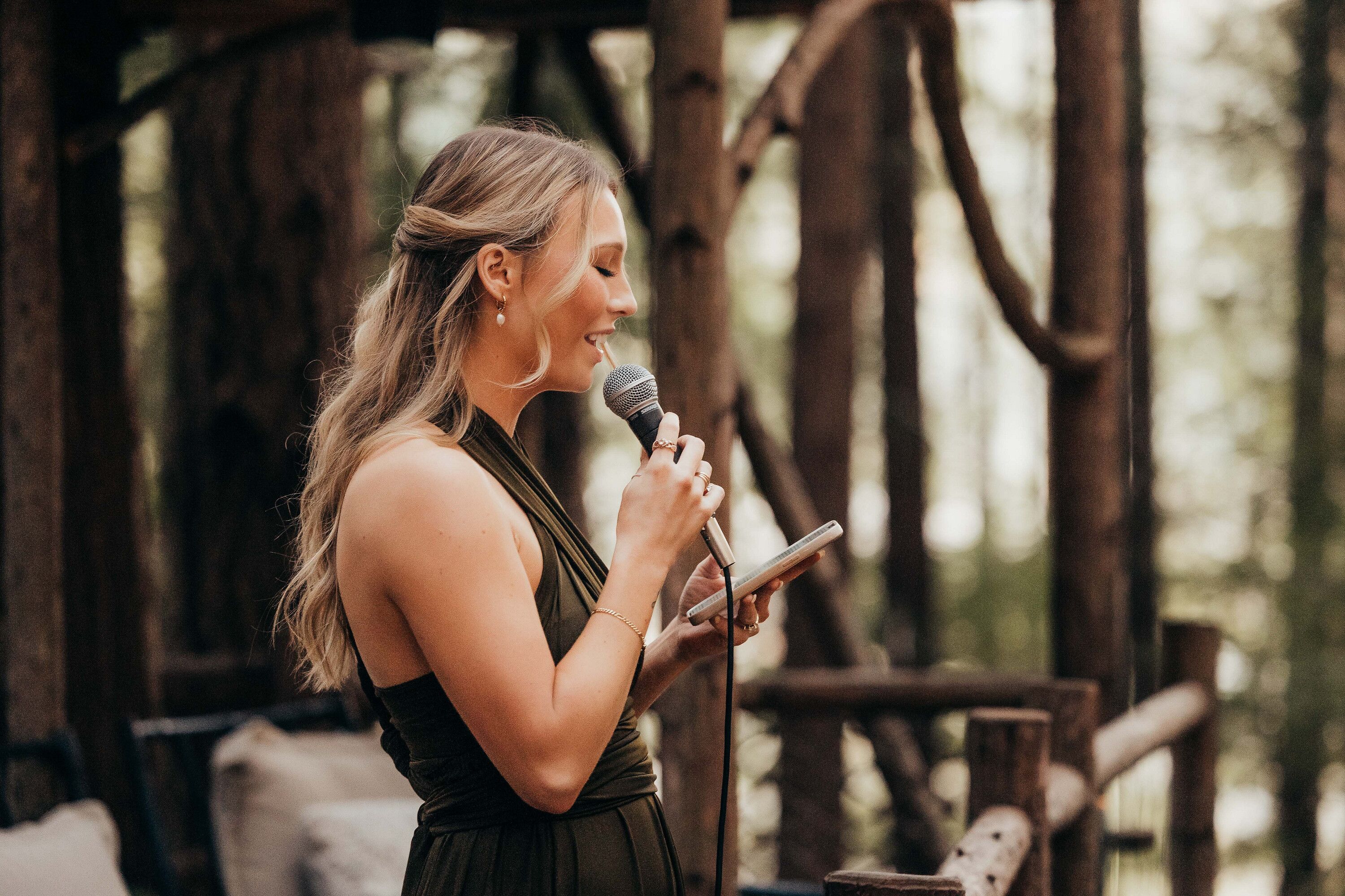 Woman Giving a Speech at a Whimsical Forest Wedding in the Trees