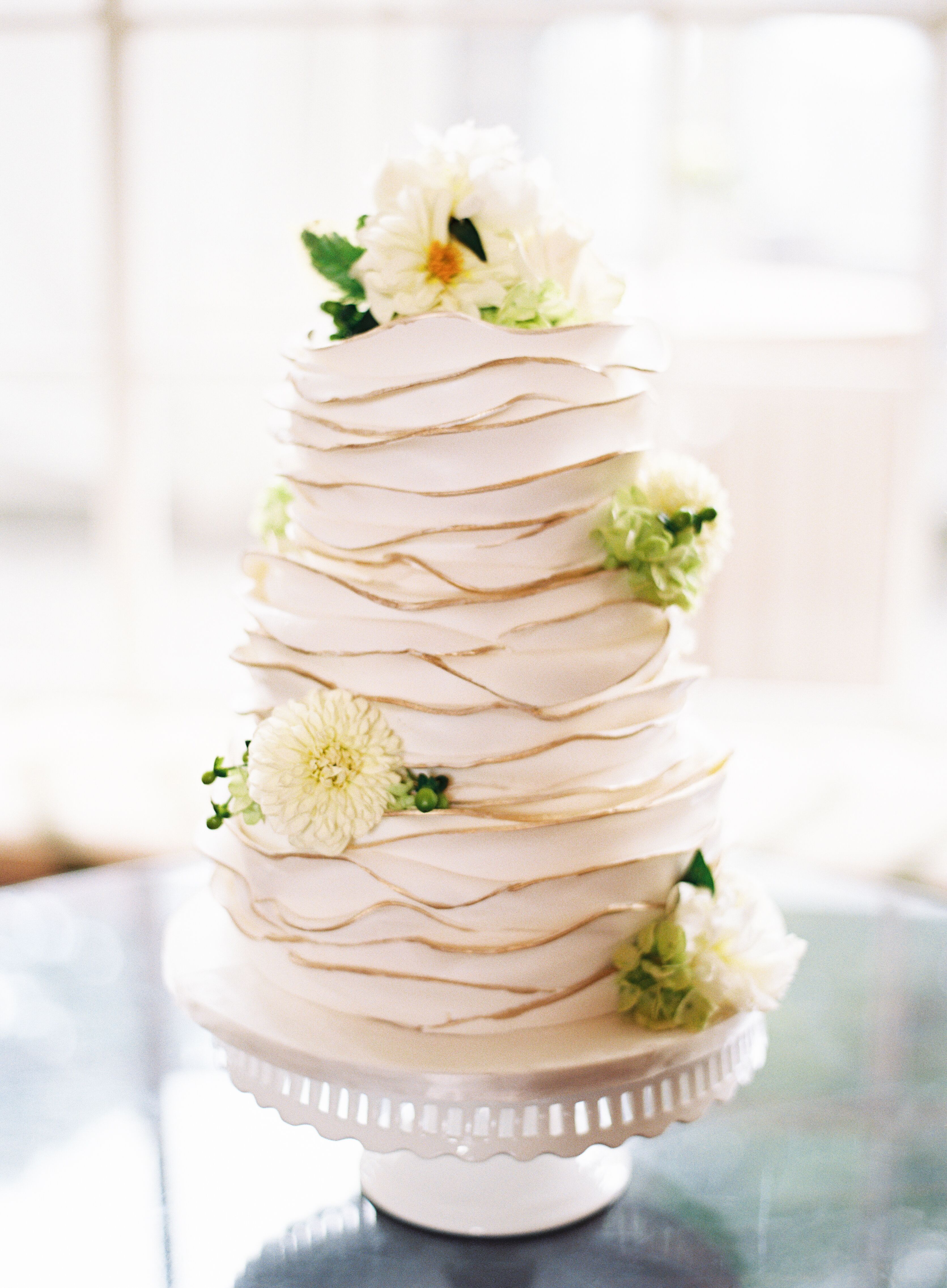 White Ruffled Wedding Cake with Flowers