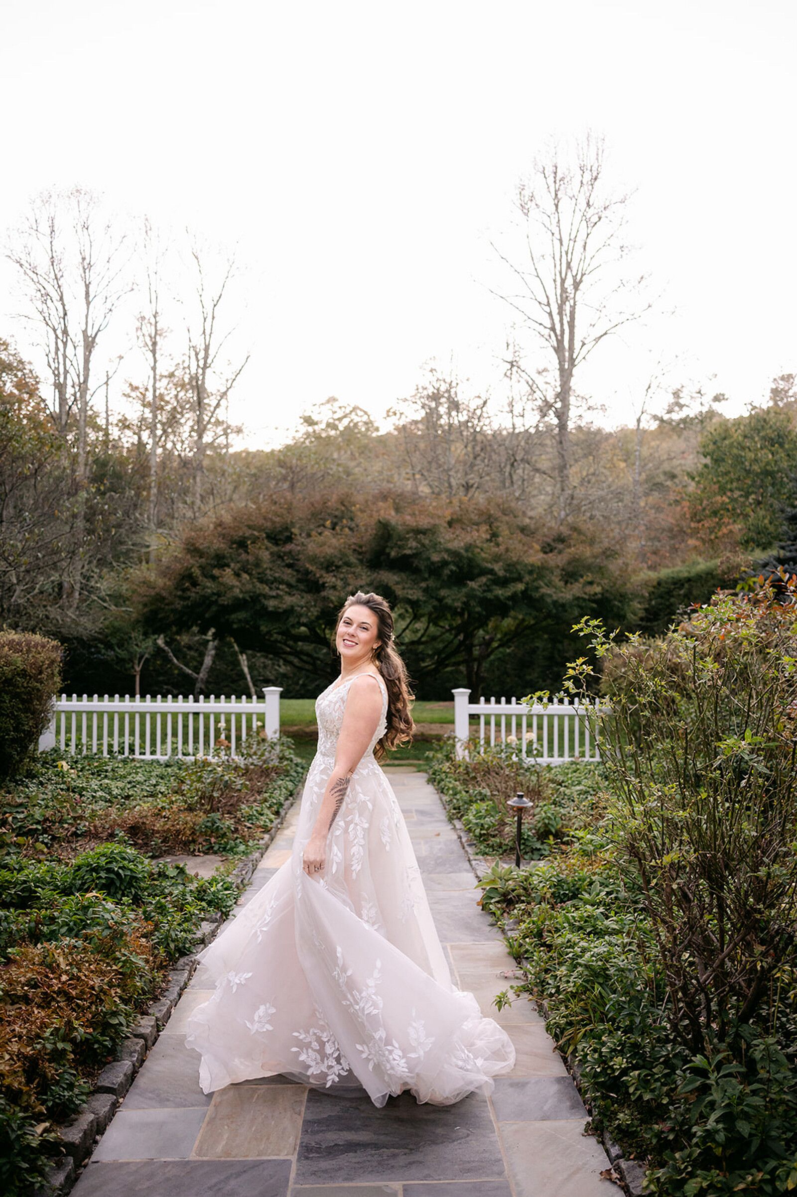 Bride in Off-White Wedding Gown With Embroidered Leaves and Flowers