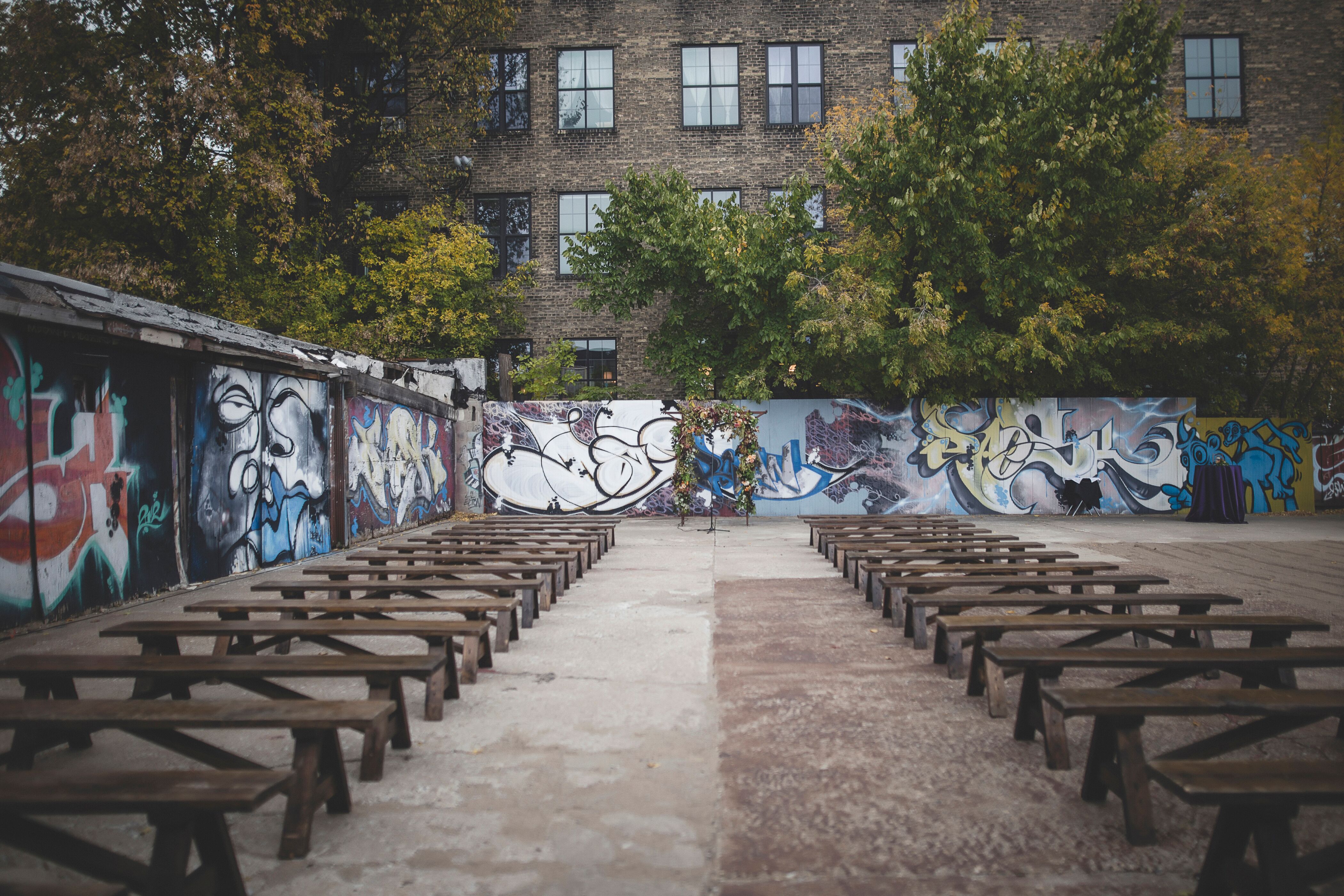 Casual Ceremony in Graffiti-Lined Courtyard
