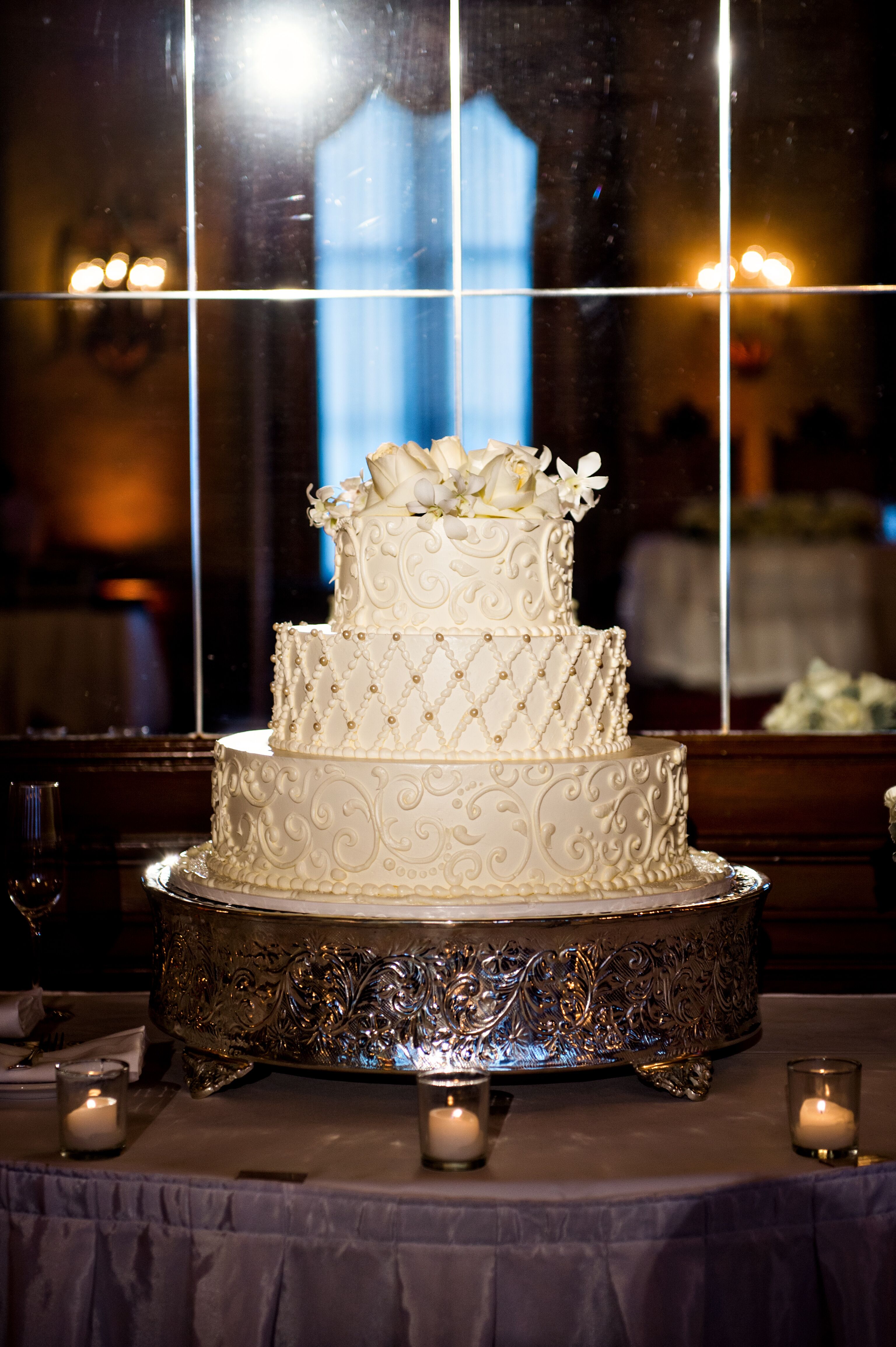 Intricate Three-Layer Cake With Flower Topper