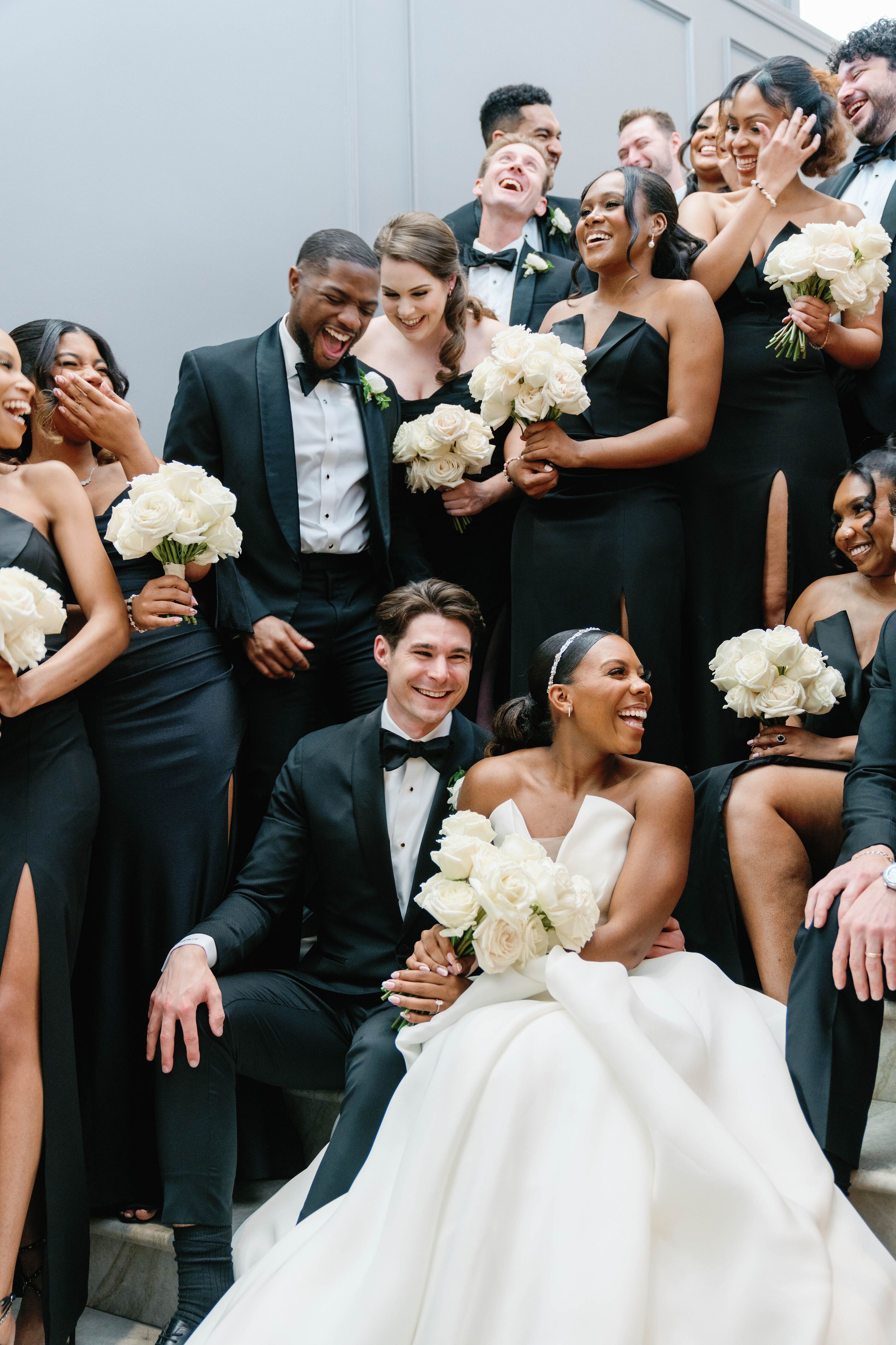 Bride in A-Line Gown With Groom in Tuxedo on Stairs With Bridal Party ...