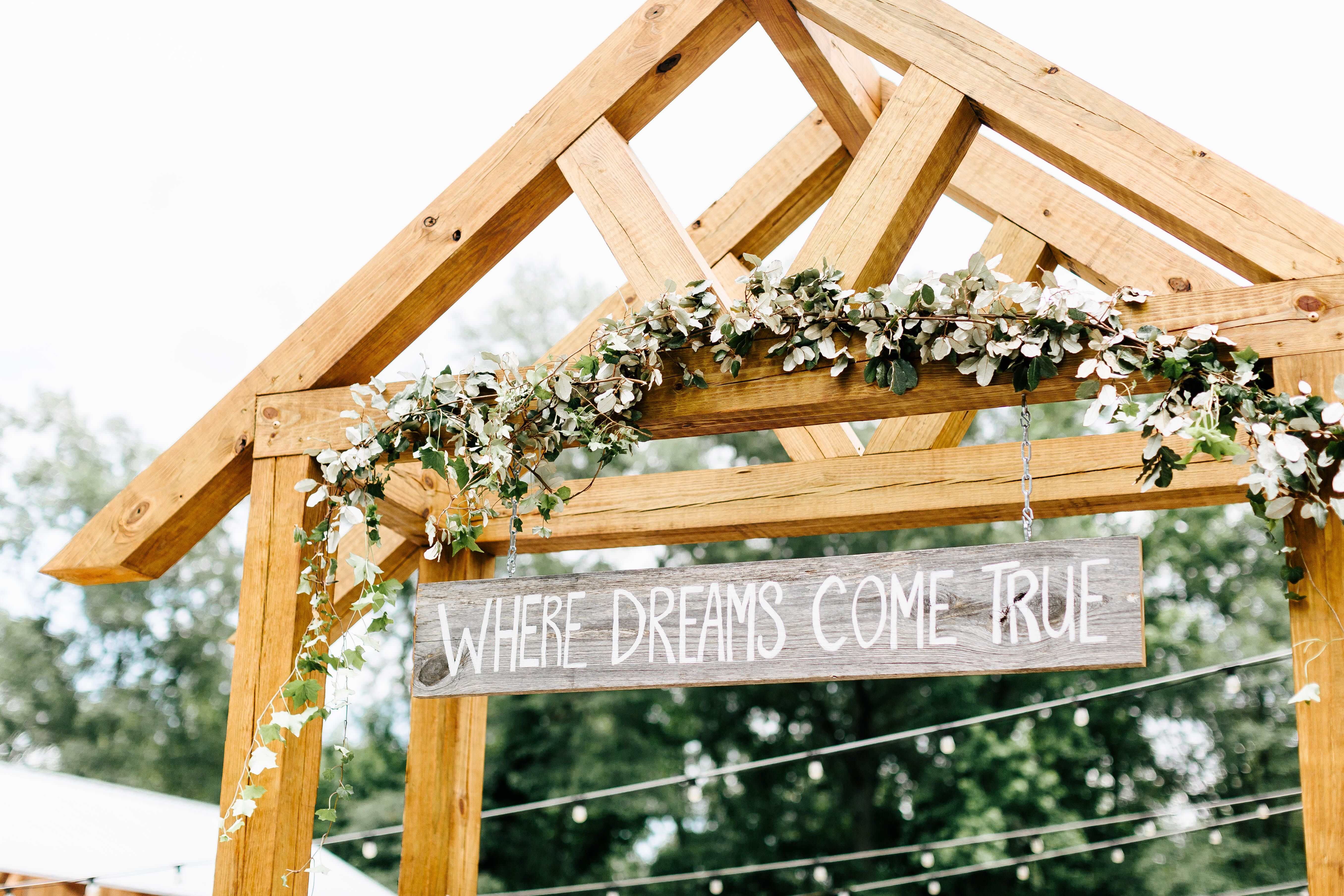 Wooden Arch With Garland and DIY Wooden Sign