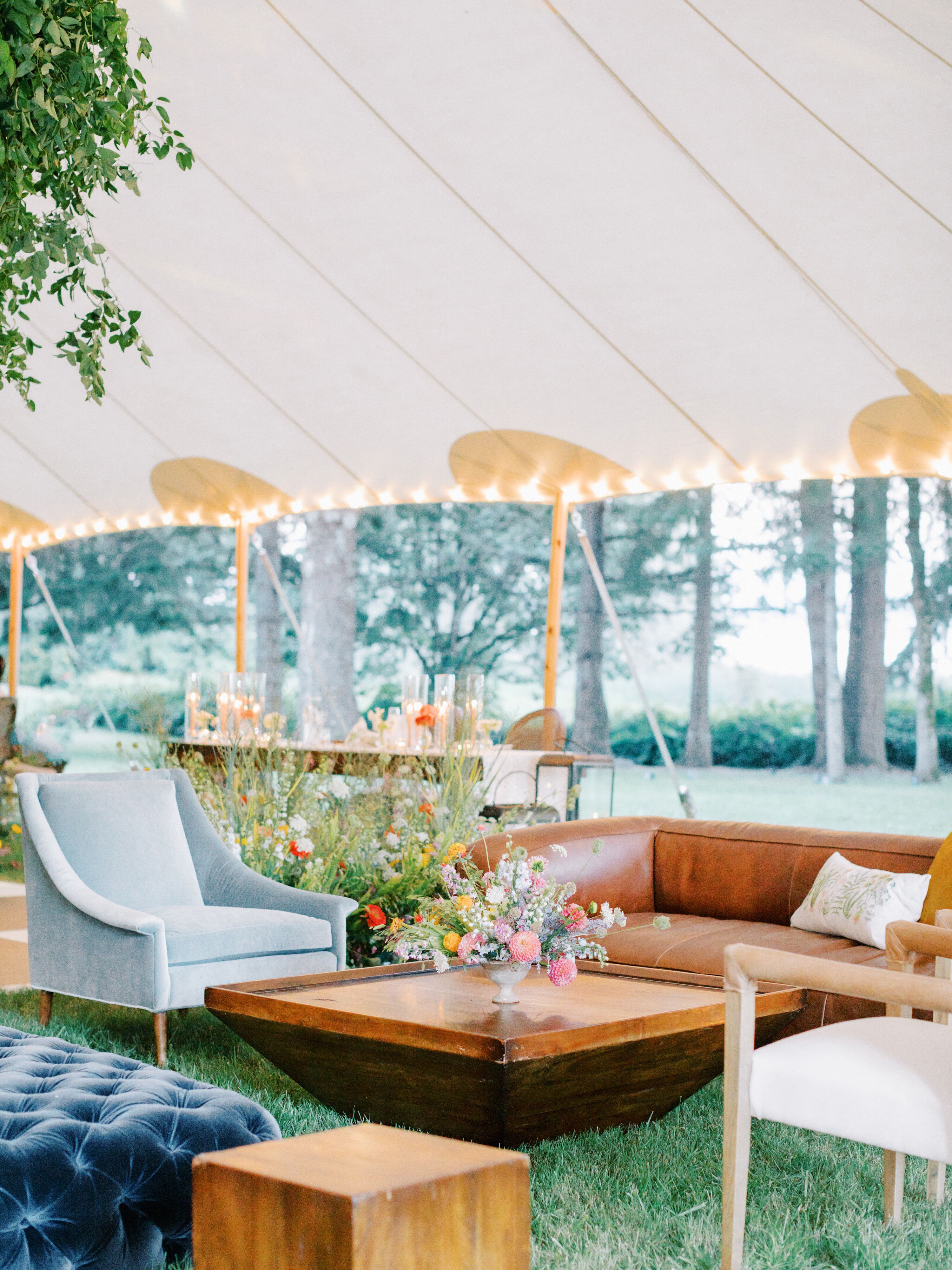 Lounge Space at Tented Reception With Eclectic Sofa and Chairs, Wildflowers