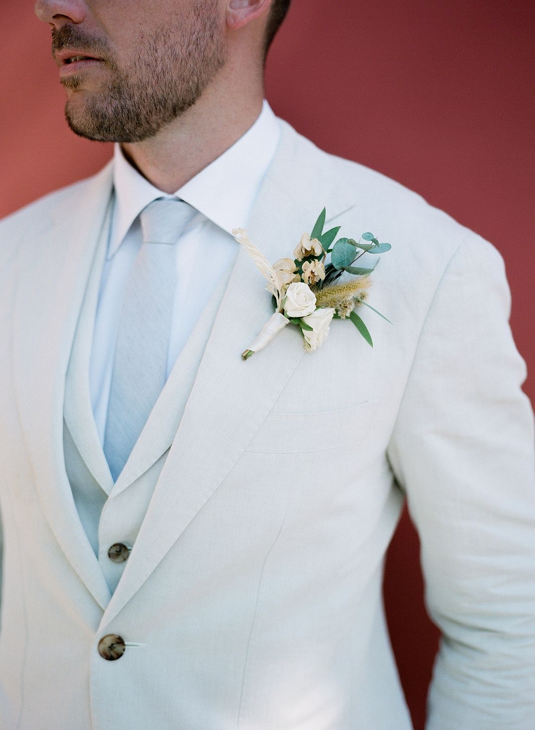 Groom in Cream Suit With Pale Blue Tie